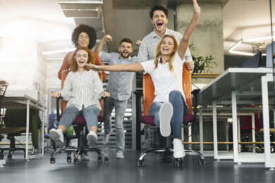 Friday Fun At Work. Group Of Cheerful Colleagues Racing On Offic ...